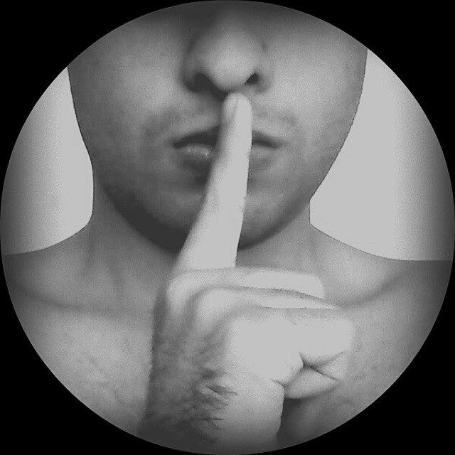 man making silent sign - ClearHealthCosts